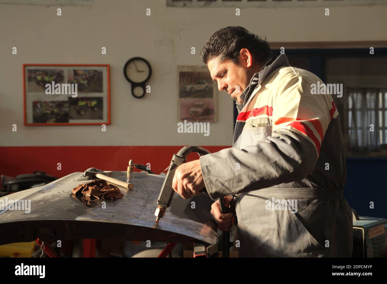A middle-aged European mechanic working in a garage Stock Photo - Alamy