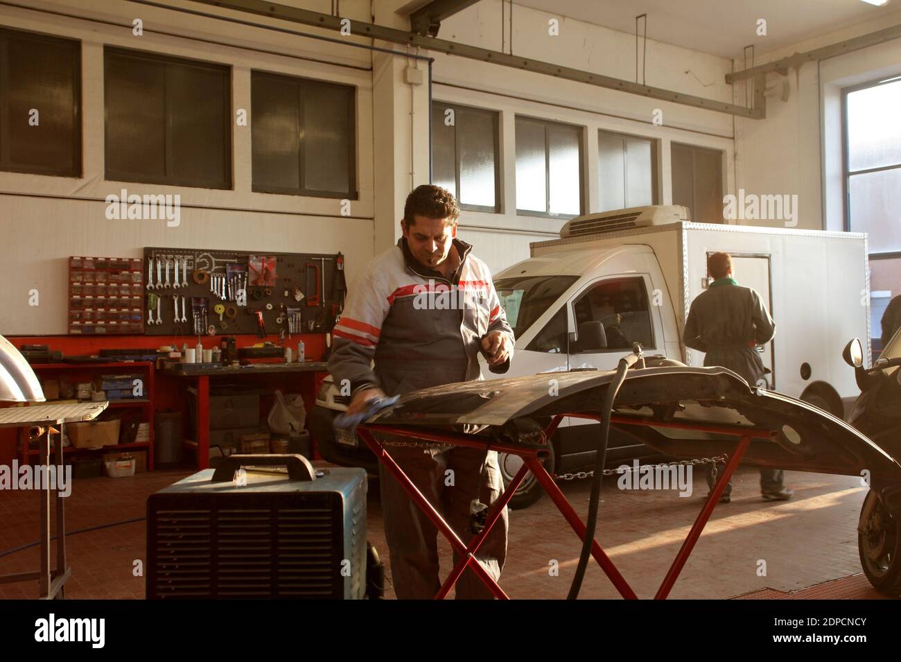 A middle-aged European mechanic working in a garag Stock Photo - Alamy