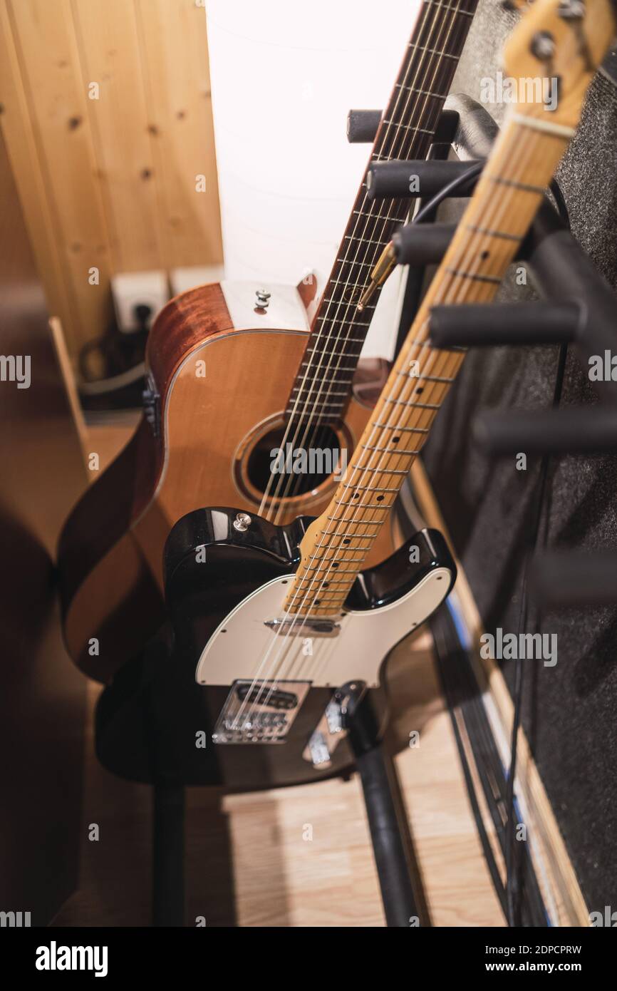 A vertical shot of a classic and electric guitars in the recording ...