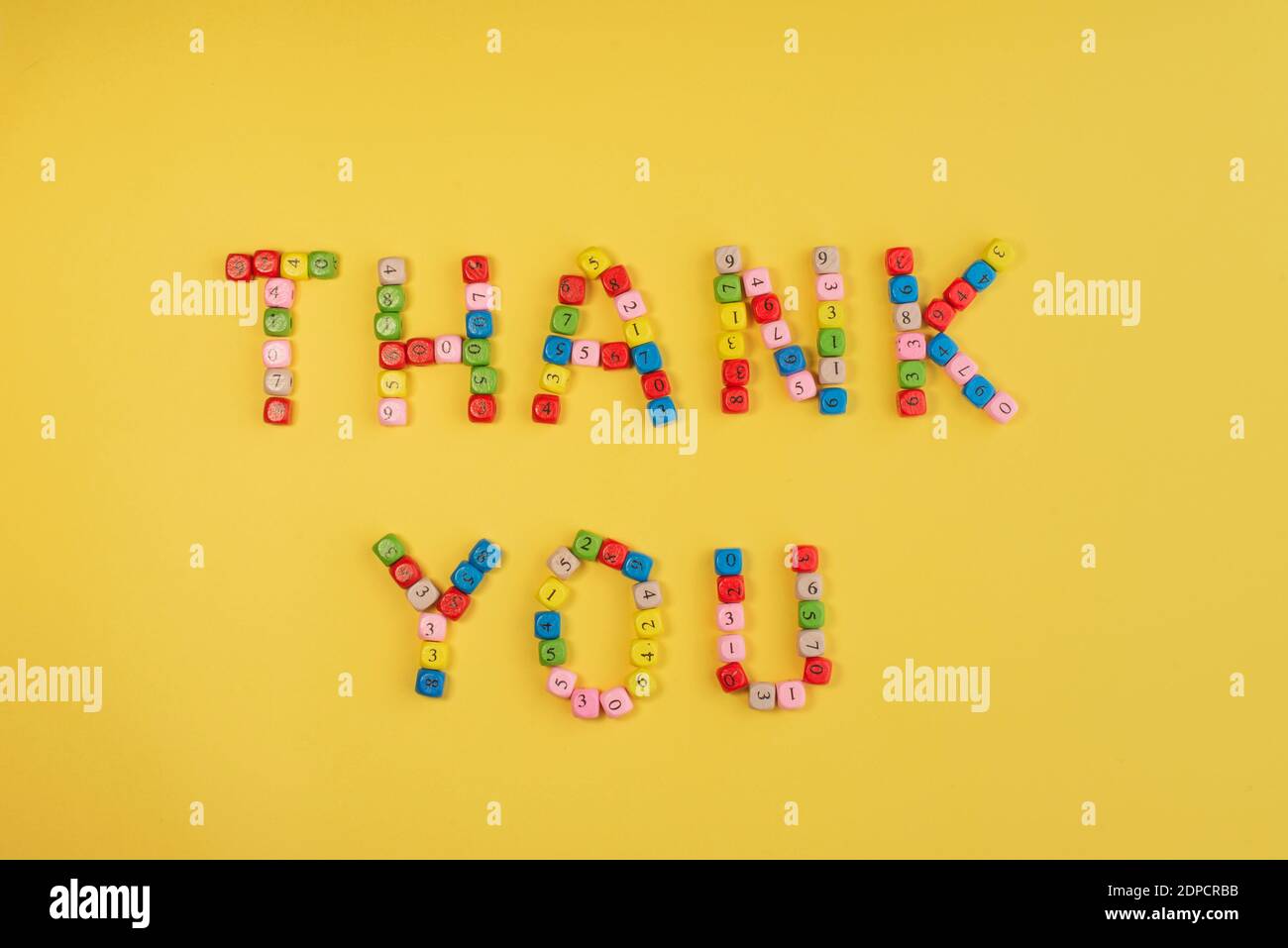 Thank you on bright yellow background. Words made of small colourful ...