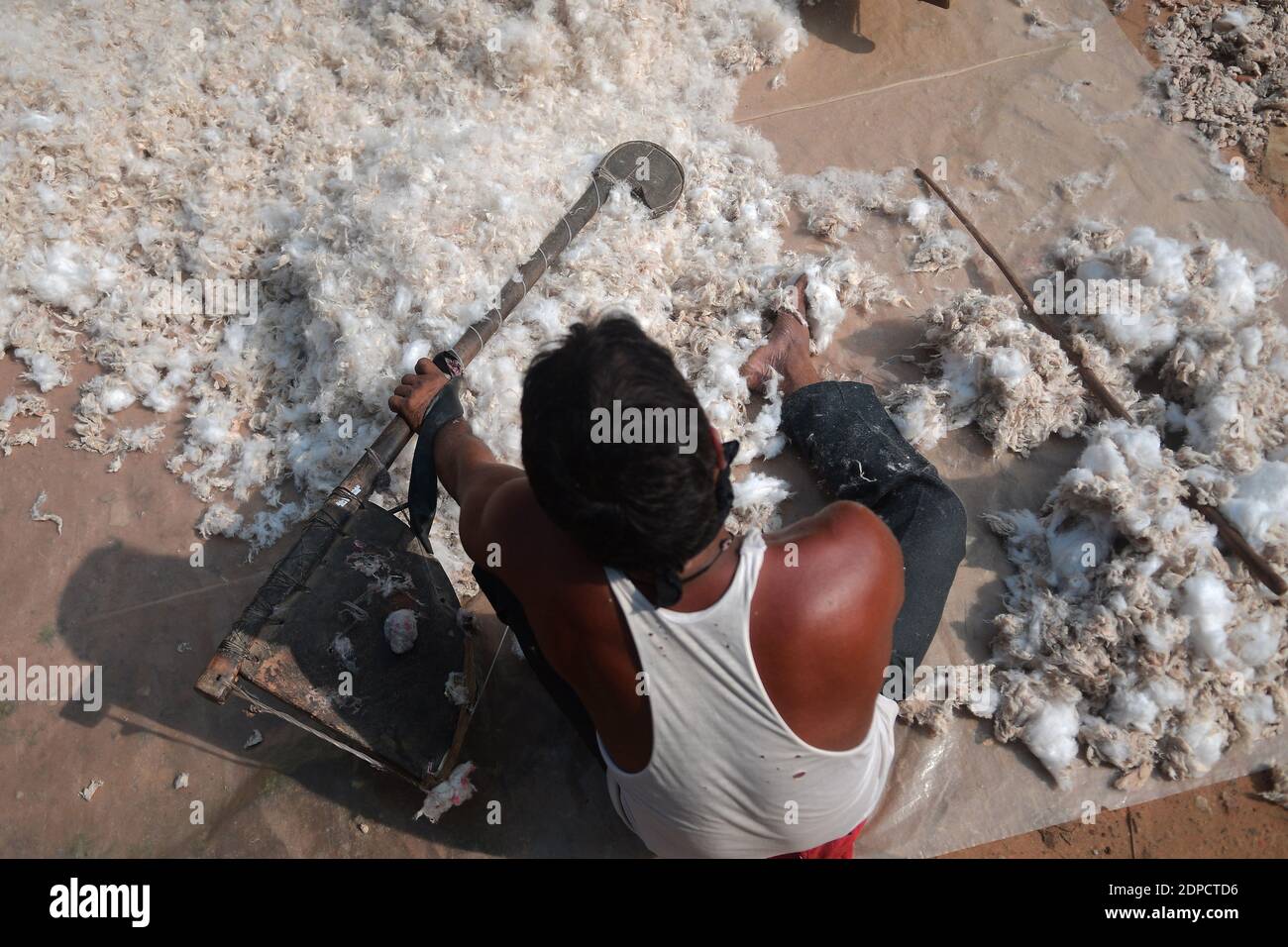 Artisans working at a cotton factory during the beating process in the ...