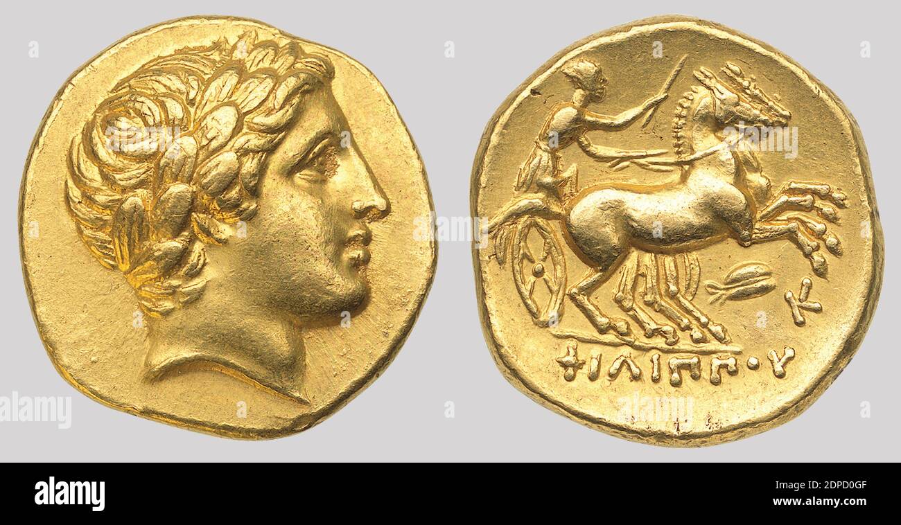 A top view of two gold coins isolated on gray surface background Stock ...