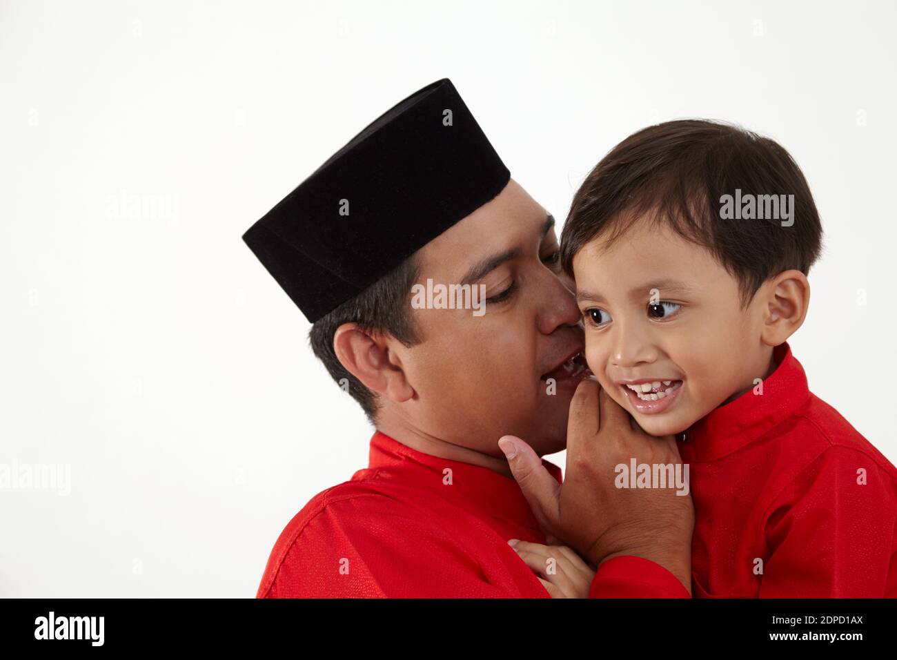 Son whispering to father hi-res stock photography and images - Alamy