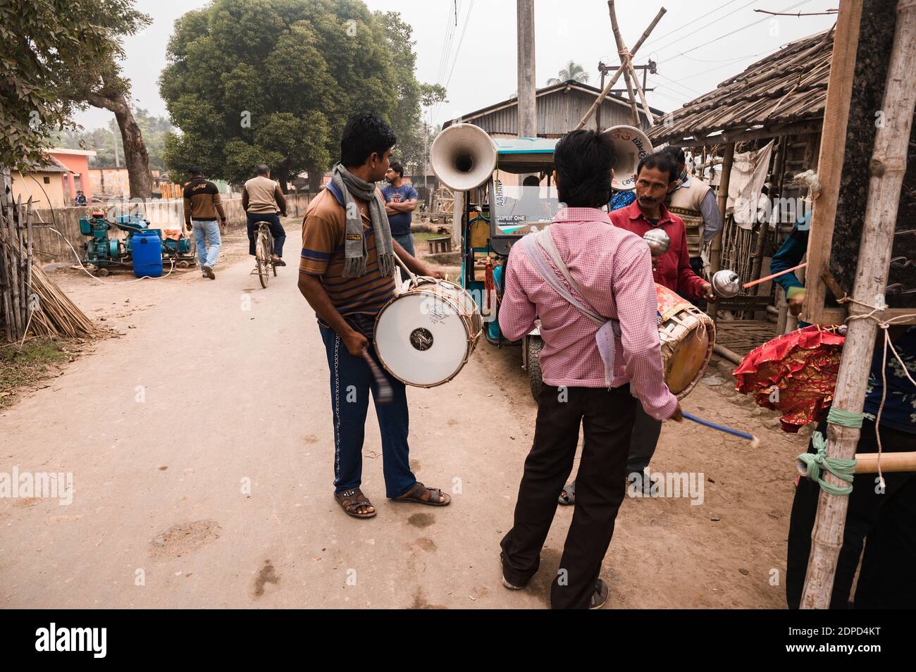 An Indian wedding band playing musical instruments in a rural wedding ...