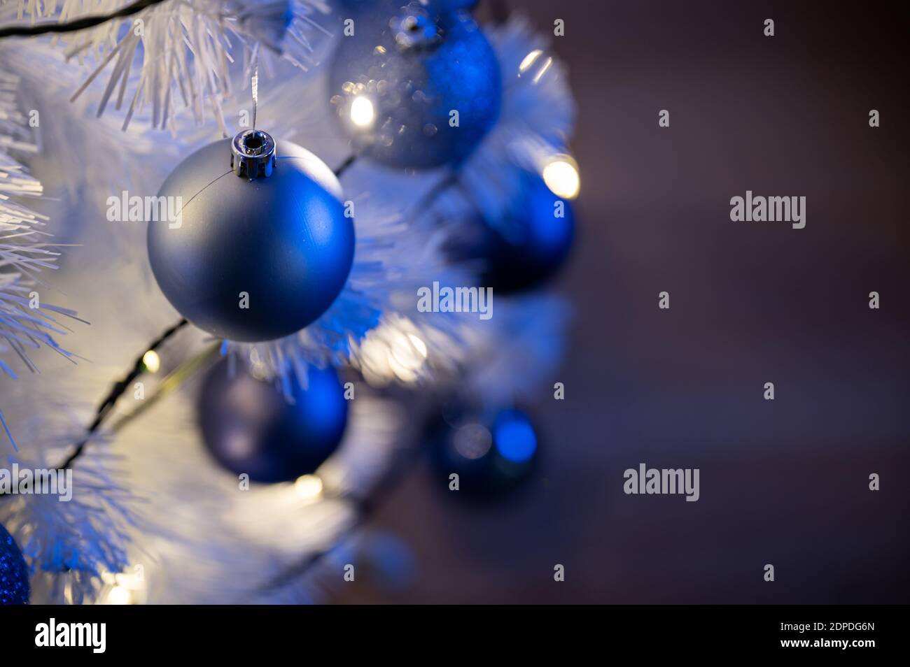 Beautiful blue holiday baubles hanging off white christmas tree Stock ...
