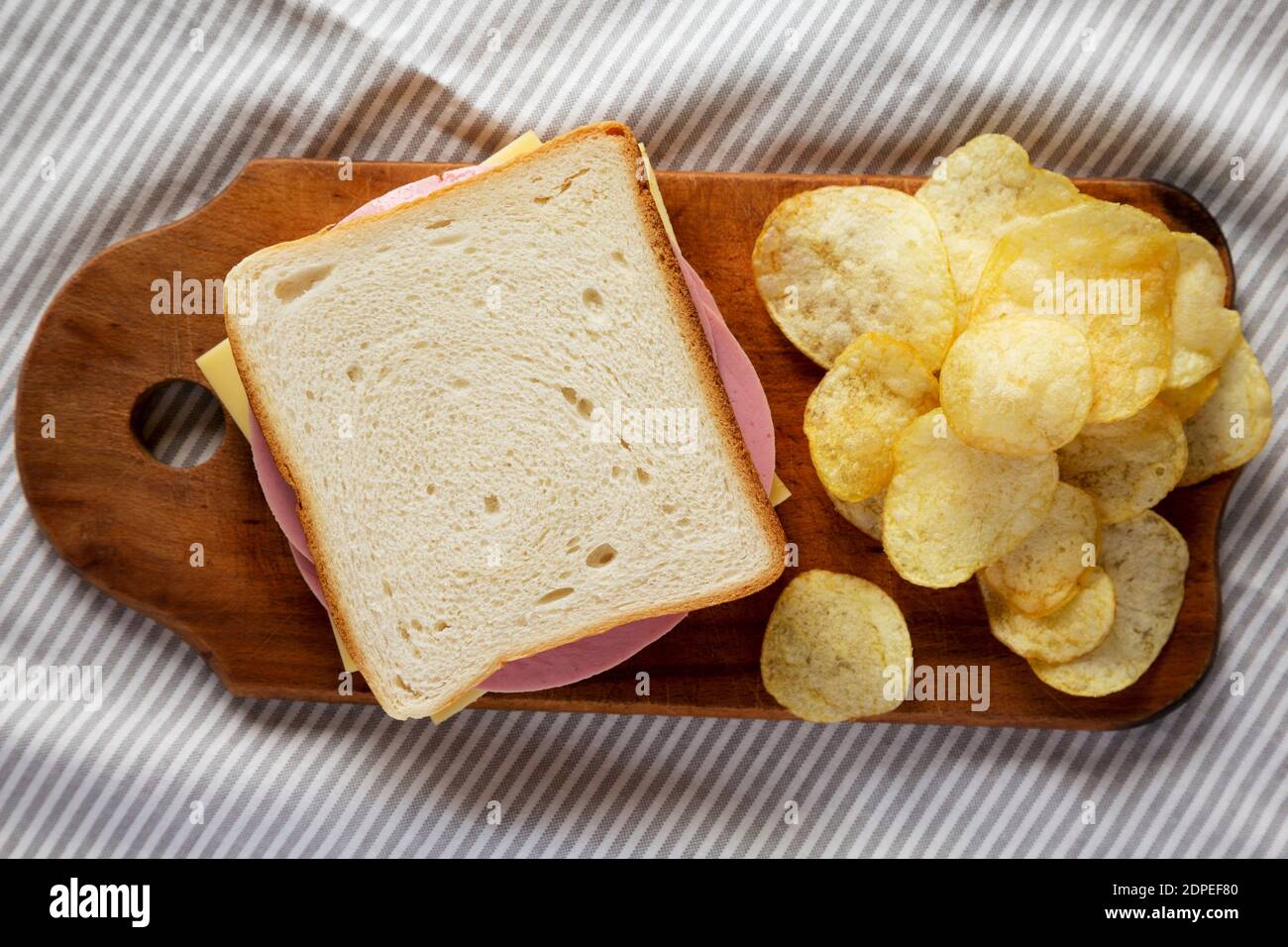 Homemade Bologna and Cheese Sandwich on a rustic wooden board on cloth ...