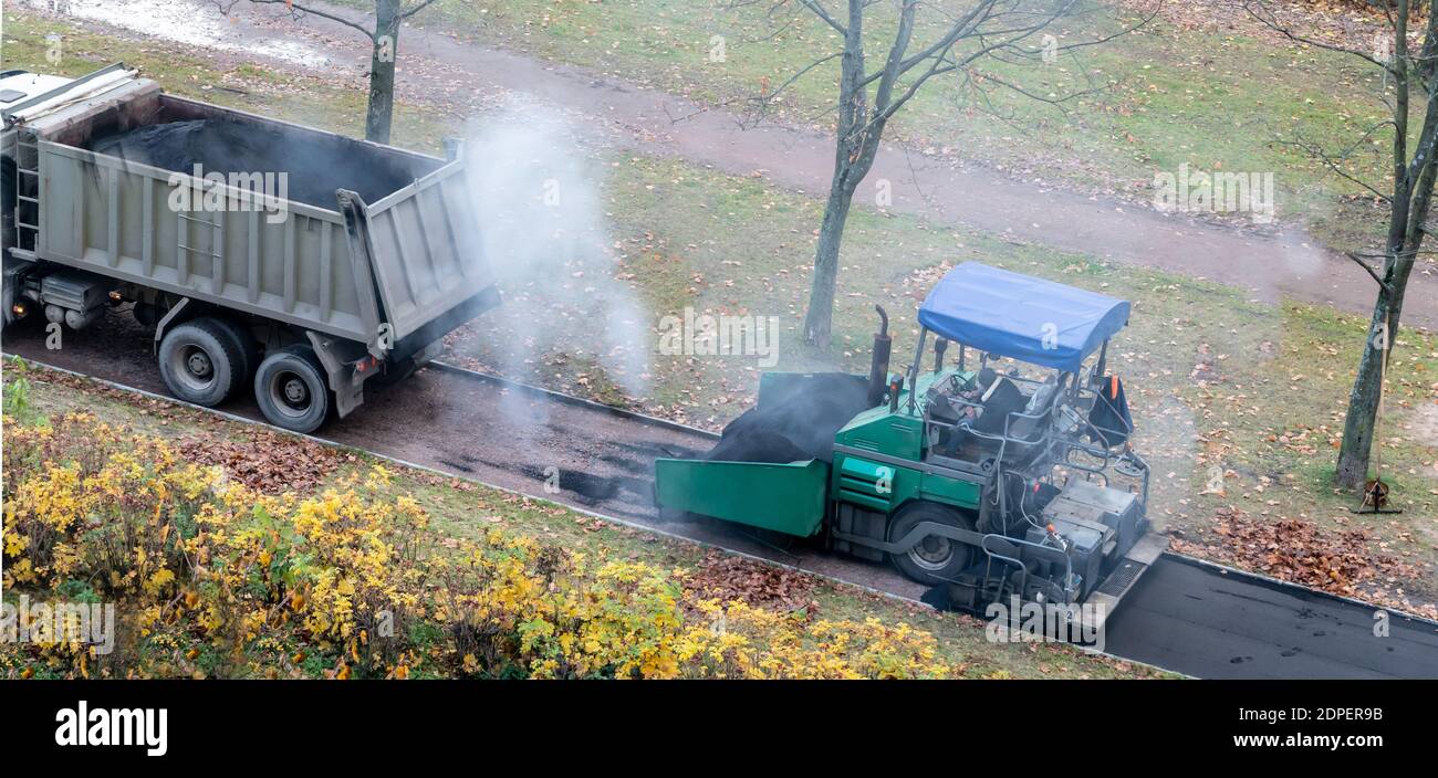 Powerful track paver stand on parking zone Stock Photo - Alamy