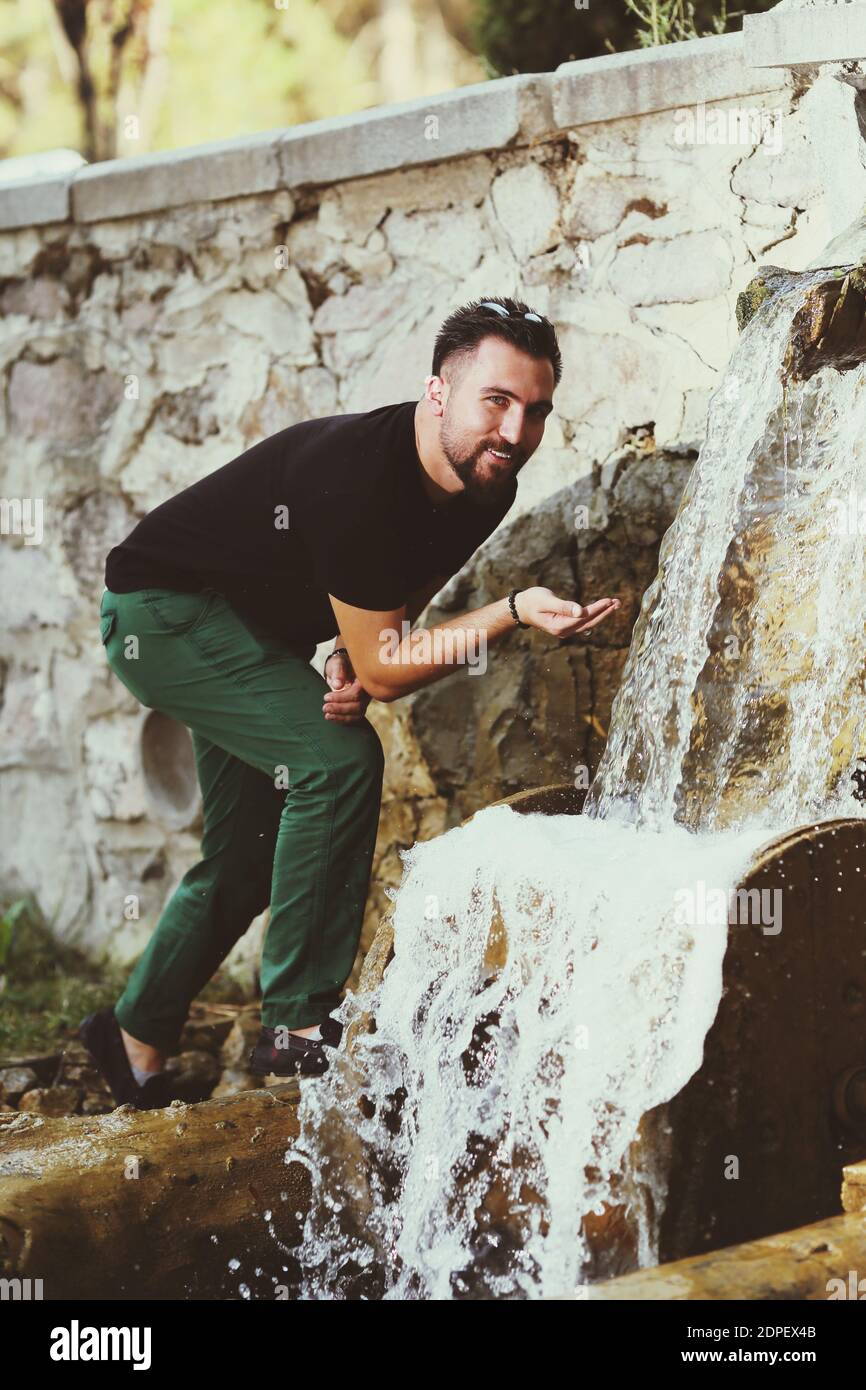 Man drinking water waterfall hi-res stock photography and images - Alamy