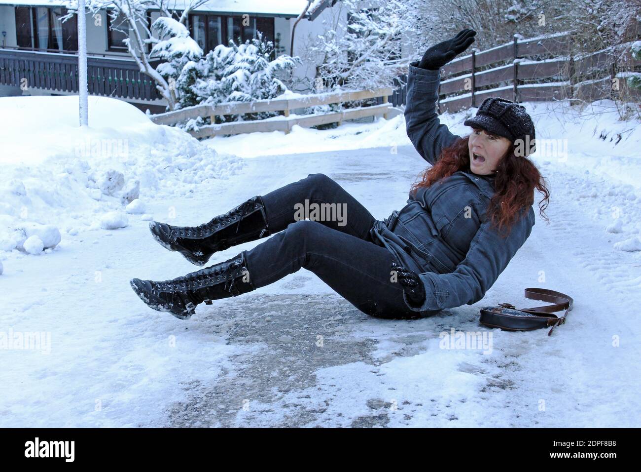 Accident danger in winter. A woman slips out on the smooth street Stock ...