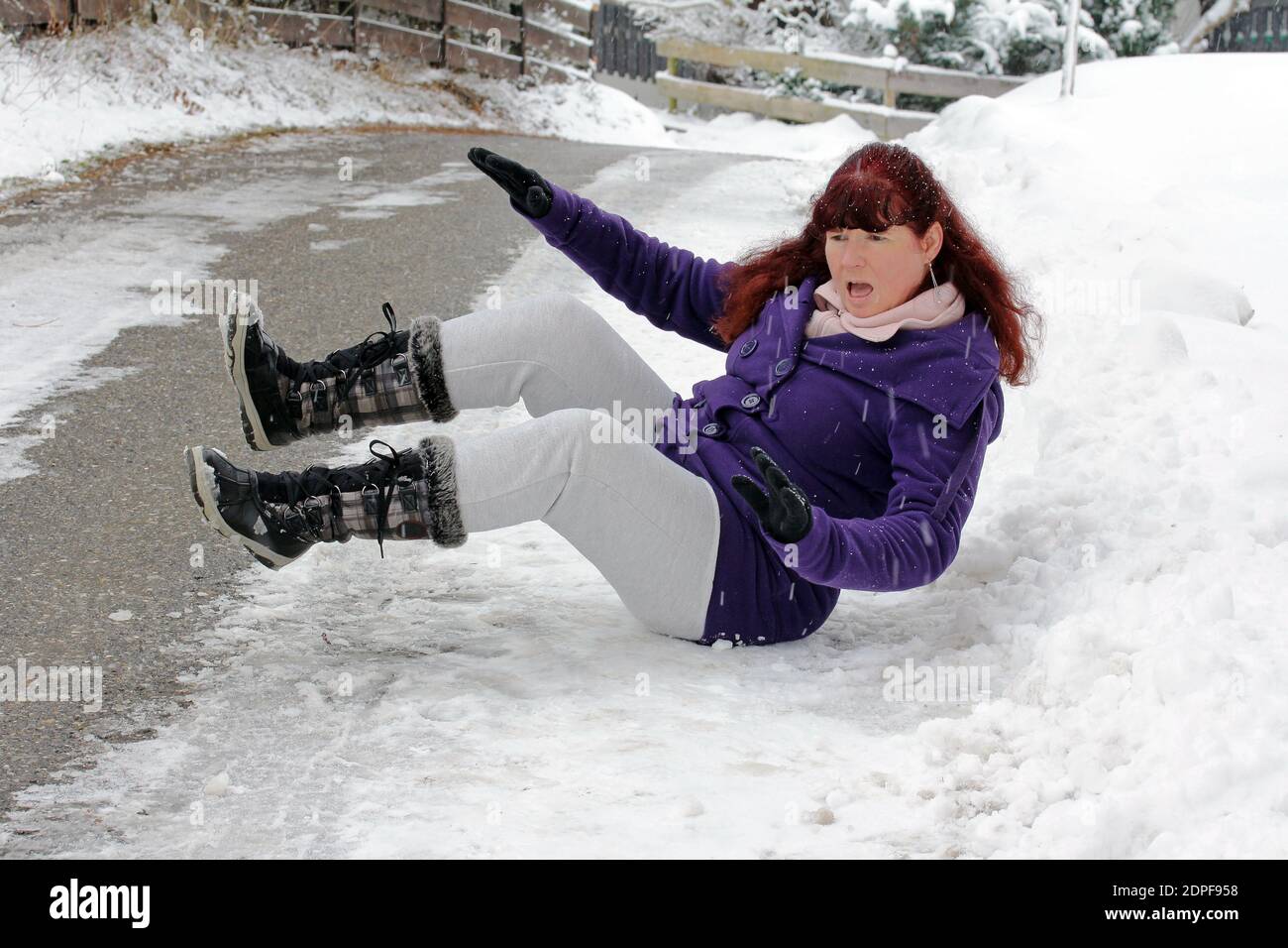 Accident danger in winter. A woman slips out on the smooth street Stock ...