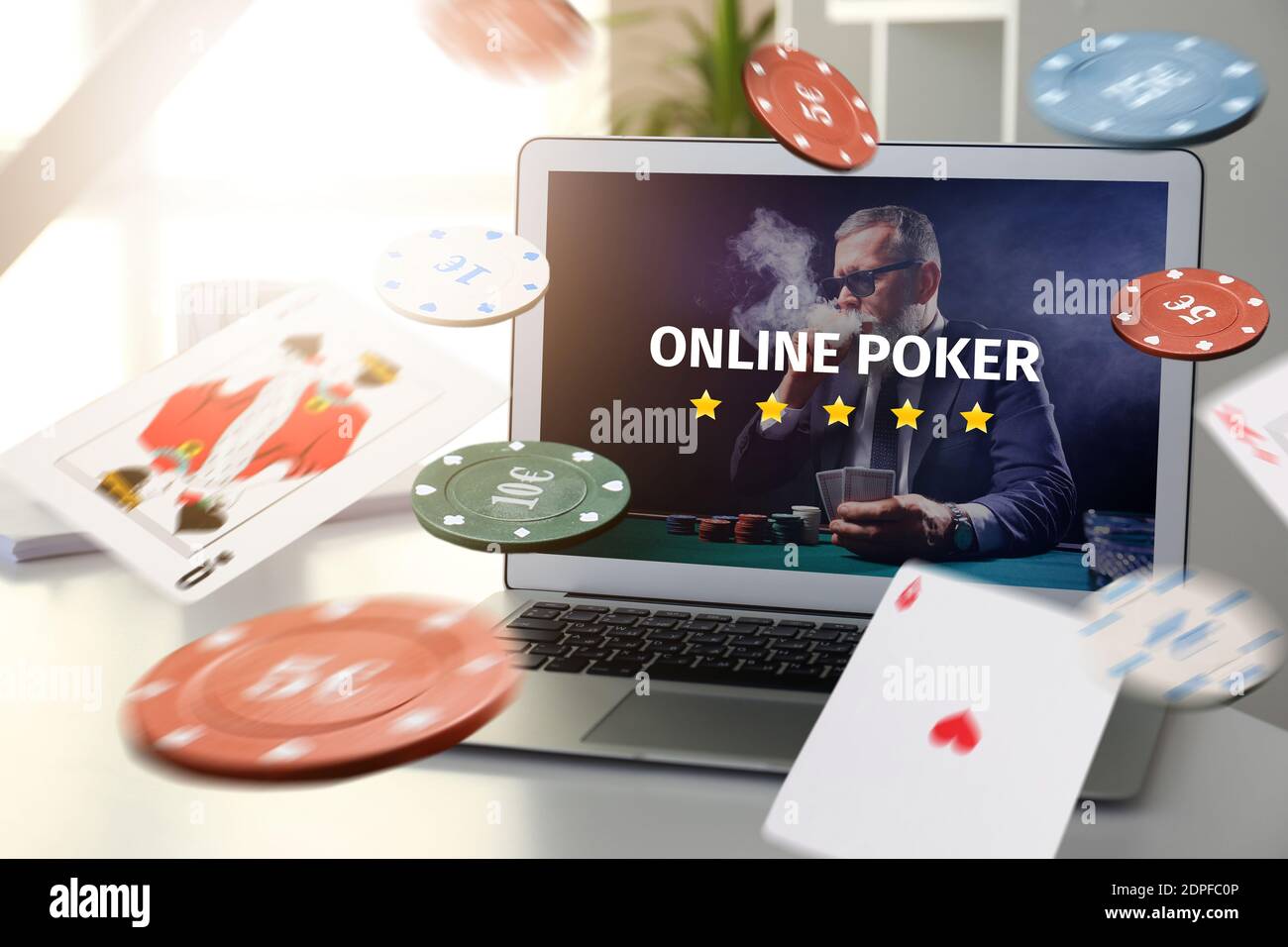 Text ONLINE POKER on screen of laptop on table in room Stock Photo - Alamy