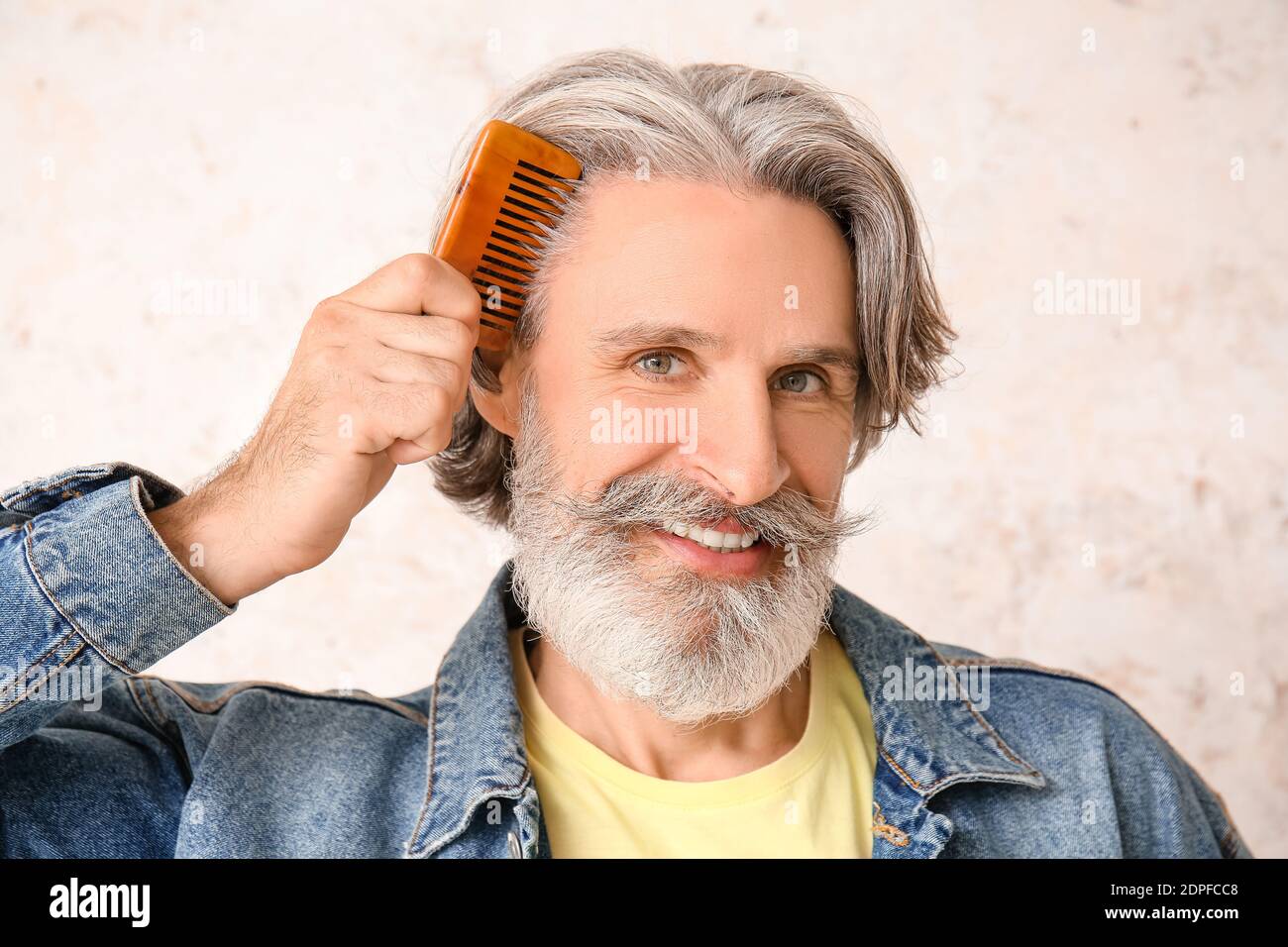 Portrait mature man combing hair hi-res stock photography and images ...