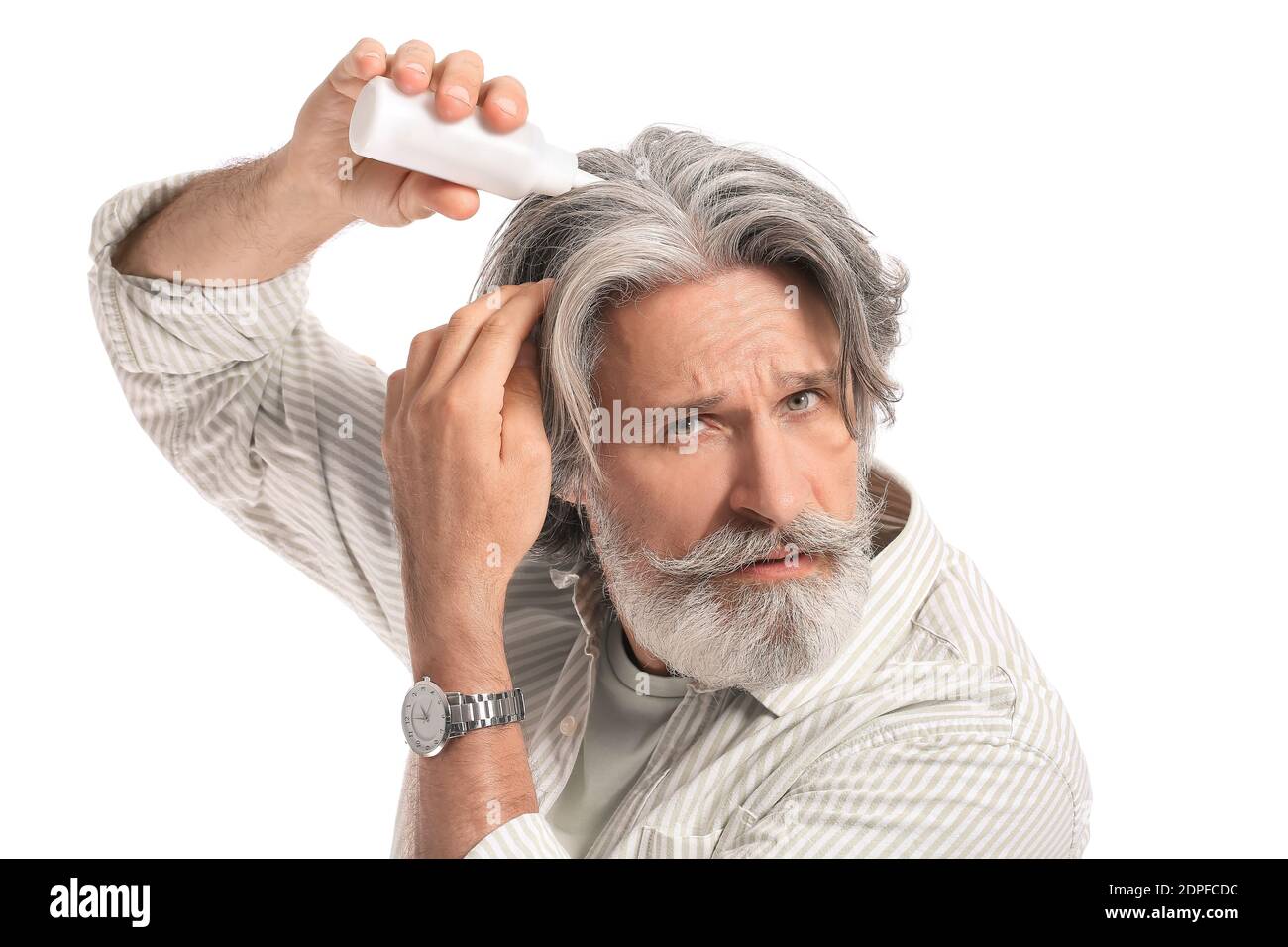 Mature man using serum for hair loss treatment on white background ...