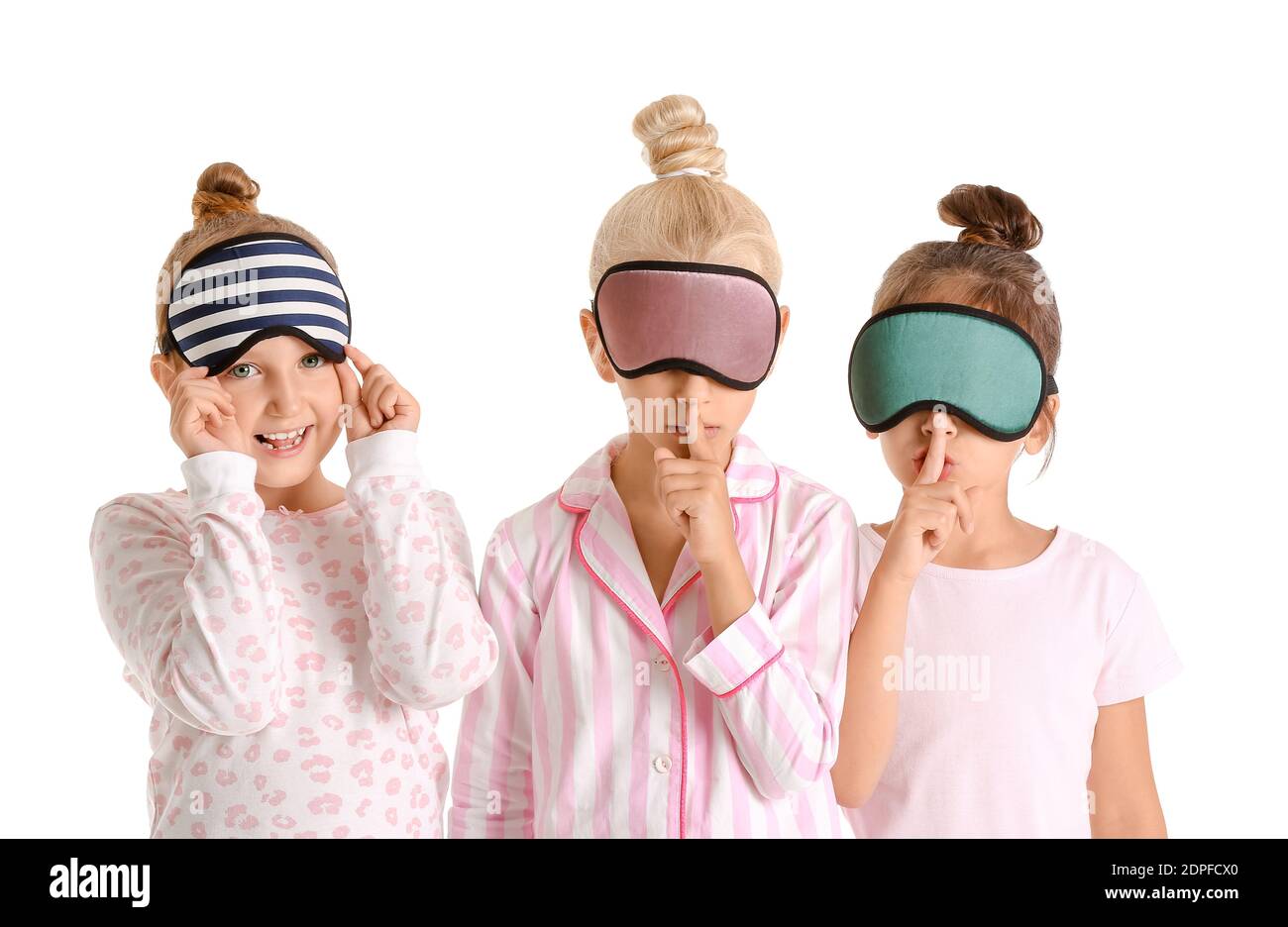 Cute little girls in pajamas and sleep masks on white background Stock ...