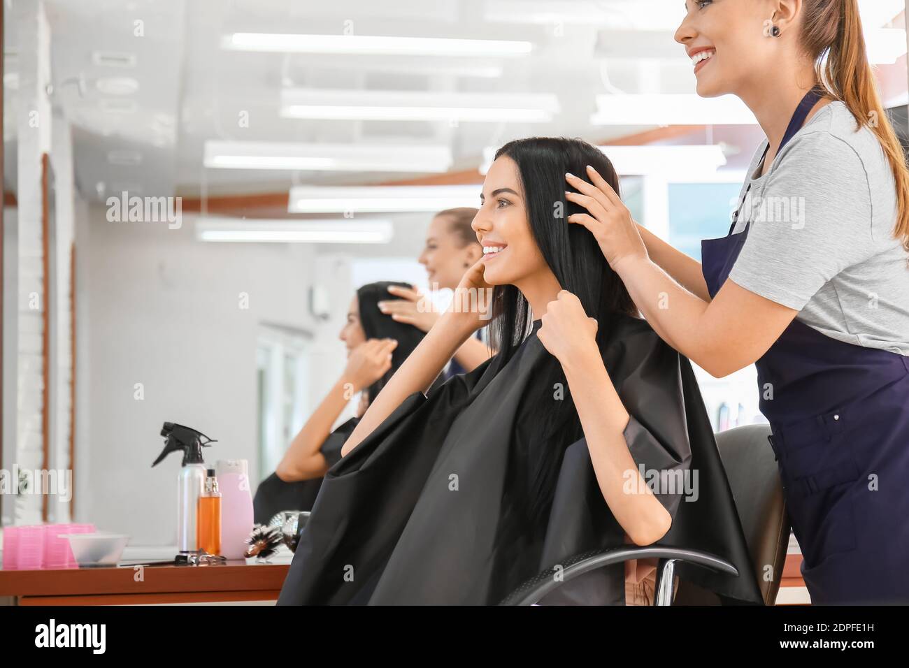 Female hairdresser working with client in salon Stock Photo - Alamy