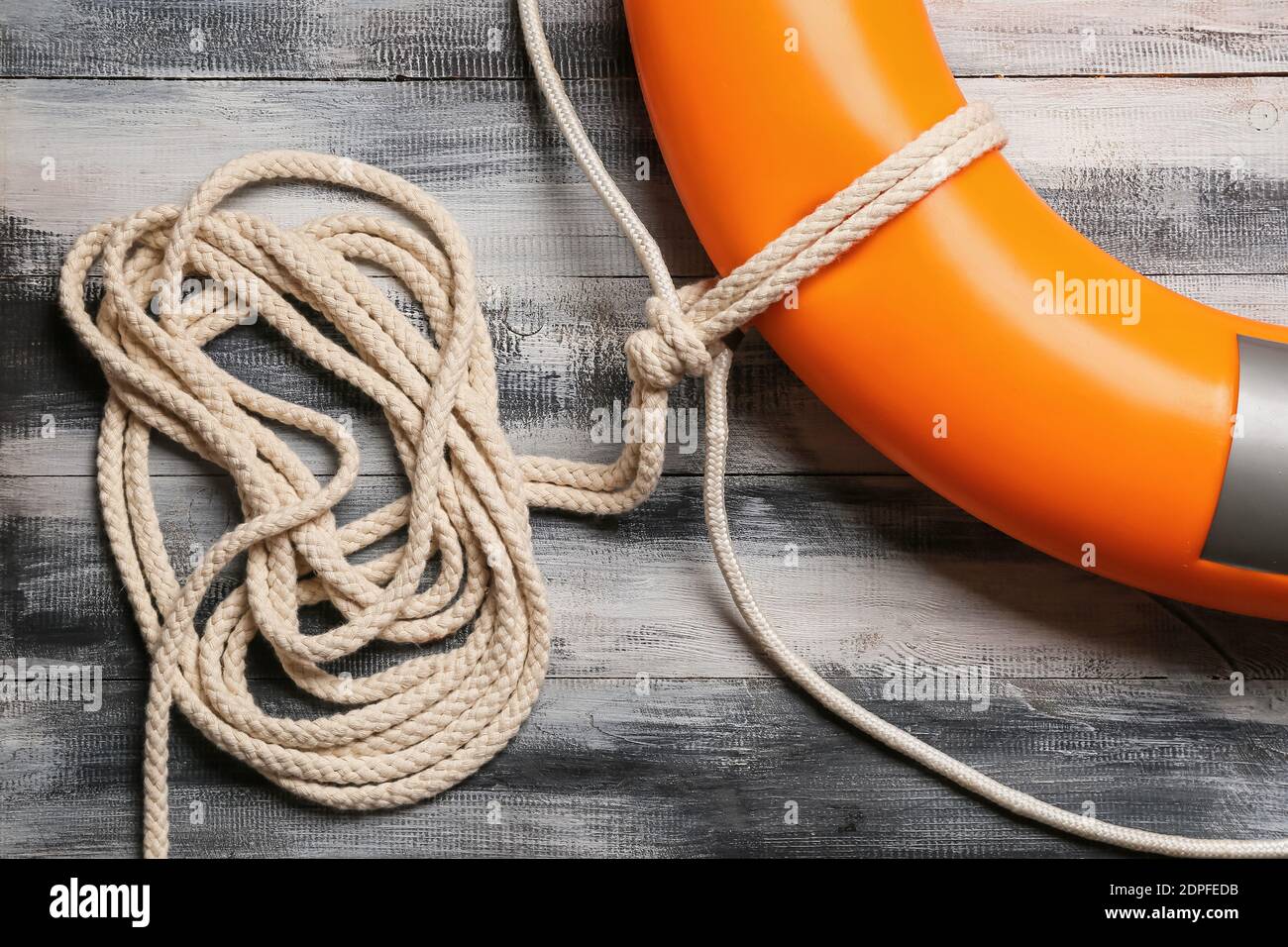 Rope and lifebuoy on wooden background Stock Photo - Alamy