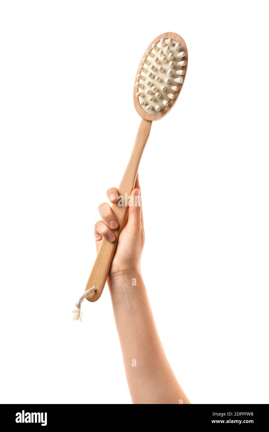 Hand with massage brush on white background Stock Photo - Alamy
