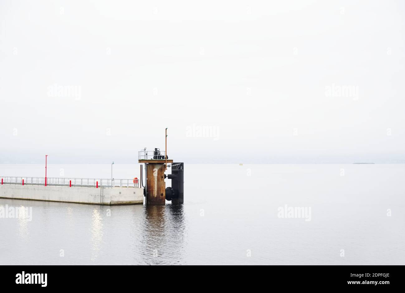 Pier with warning lights for boats at sea Stock Photo - Alamy