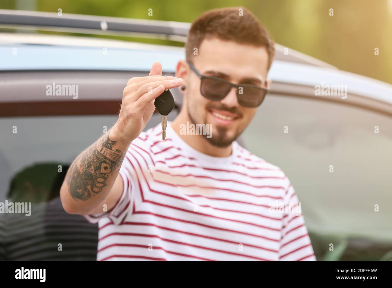 Handsome man with car key near modern car Stock Photo - Alamy
