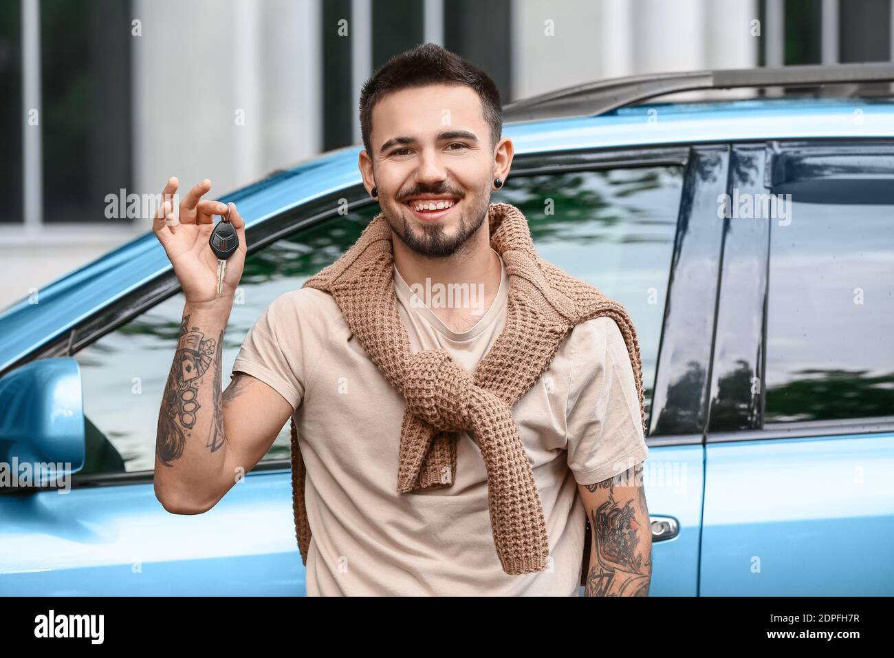 Handsome man with car key near modern car Stock Photo - Alamy