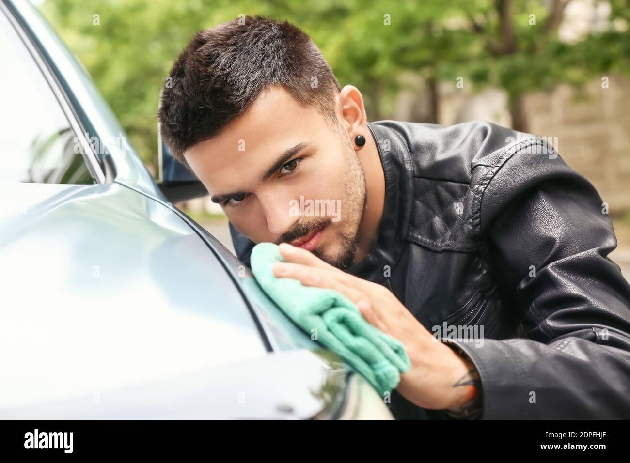 Handsome man washing his modern car Stock Photo - Alamy