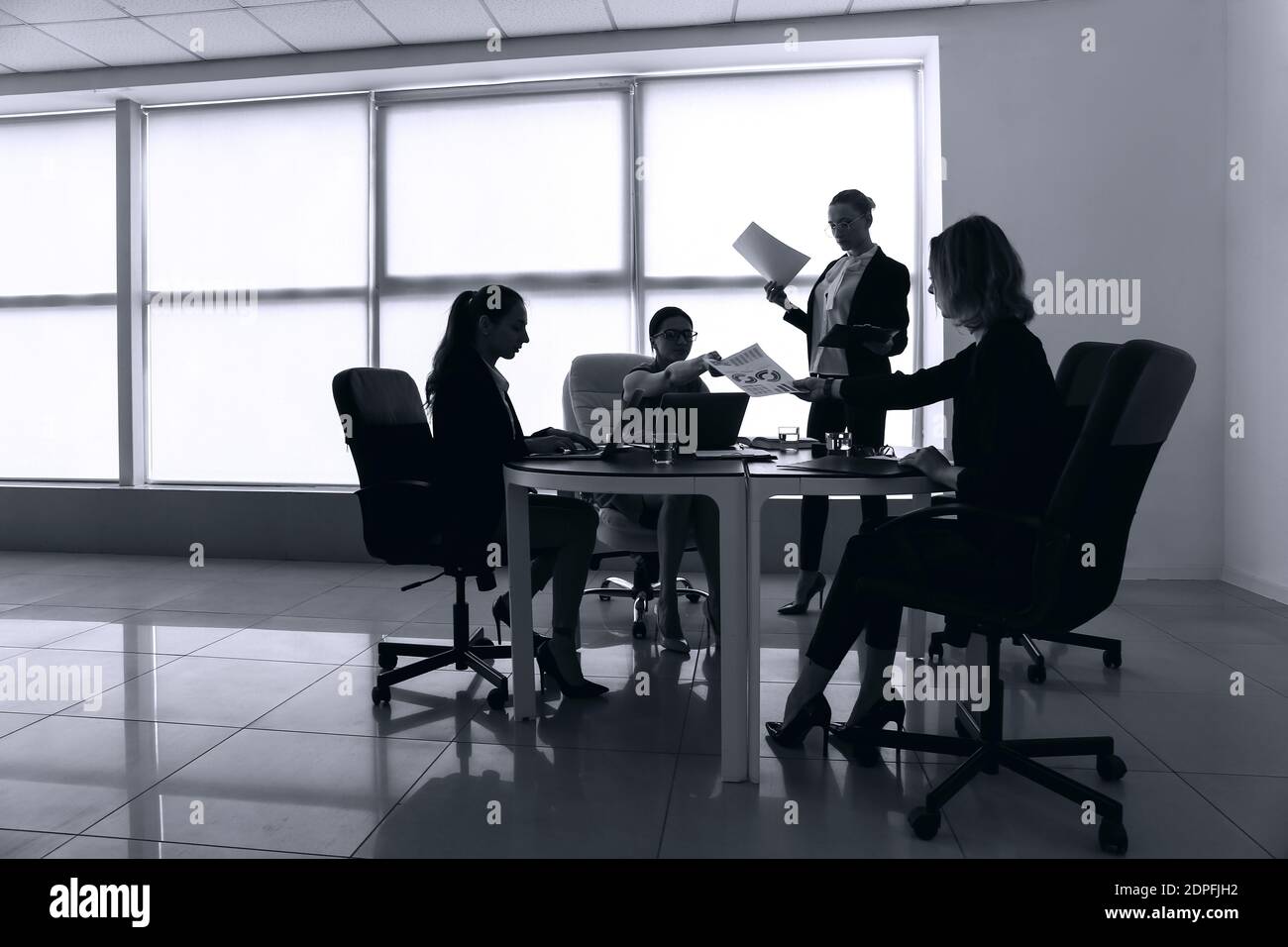 Silhouettes of businesswomen working in office Stock Photo - Alamy