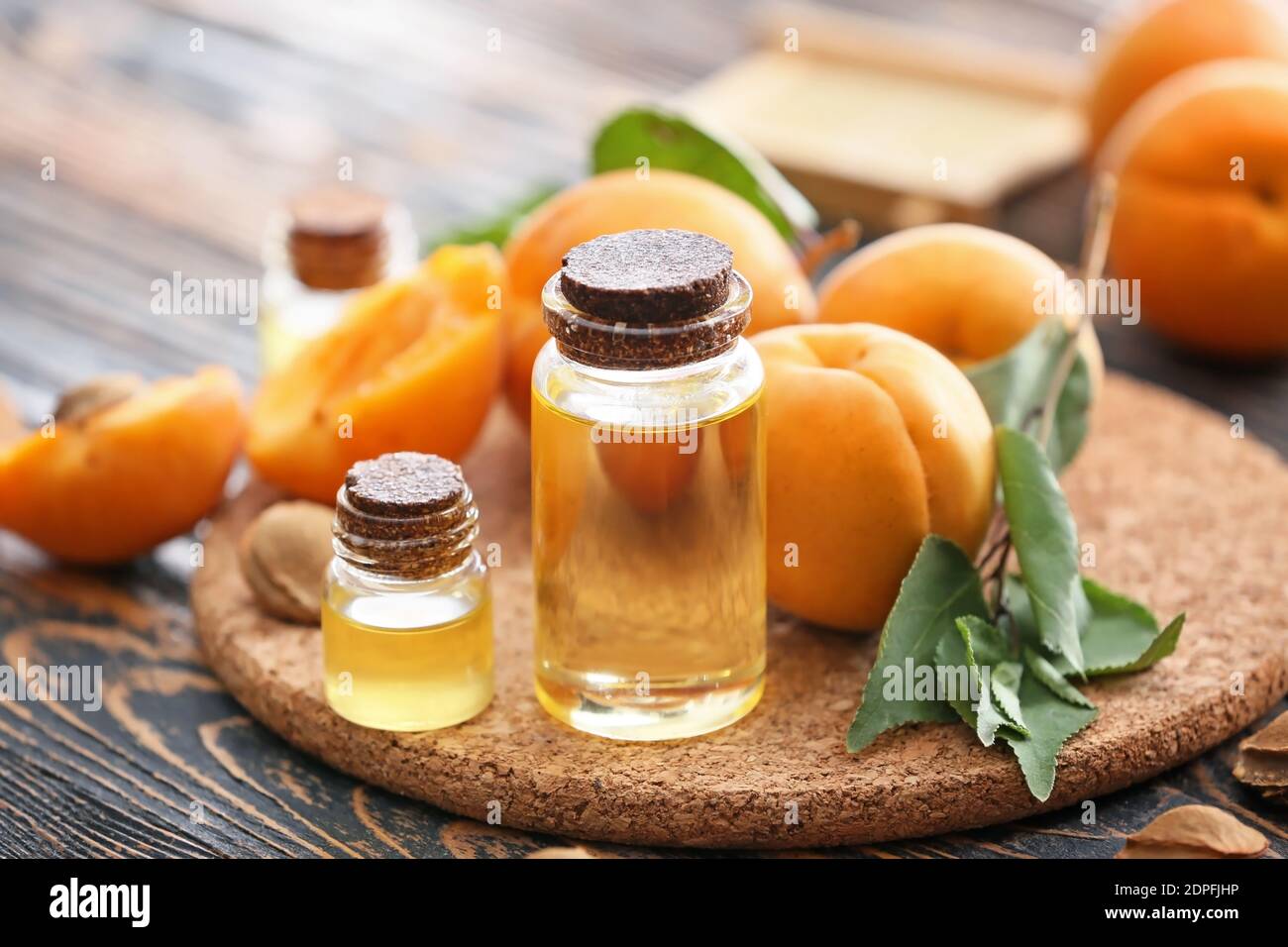Bottles of apricot essential oil on table Stock Photo - Alamy