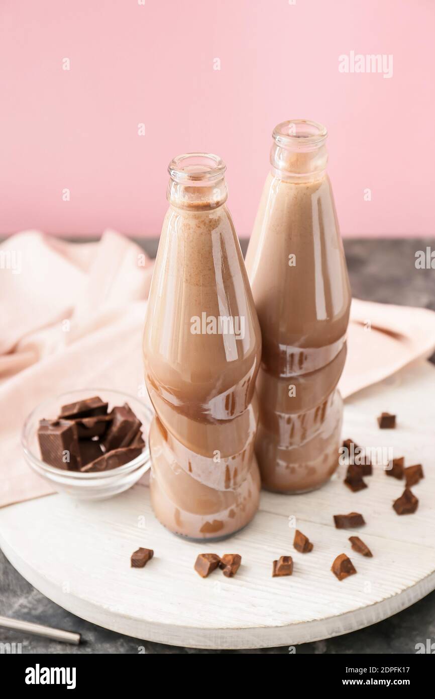 Bottles of tasty chocolate milk on table Stock Photo - Alamy