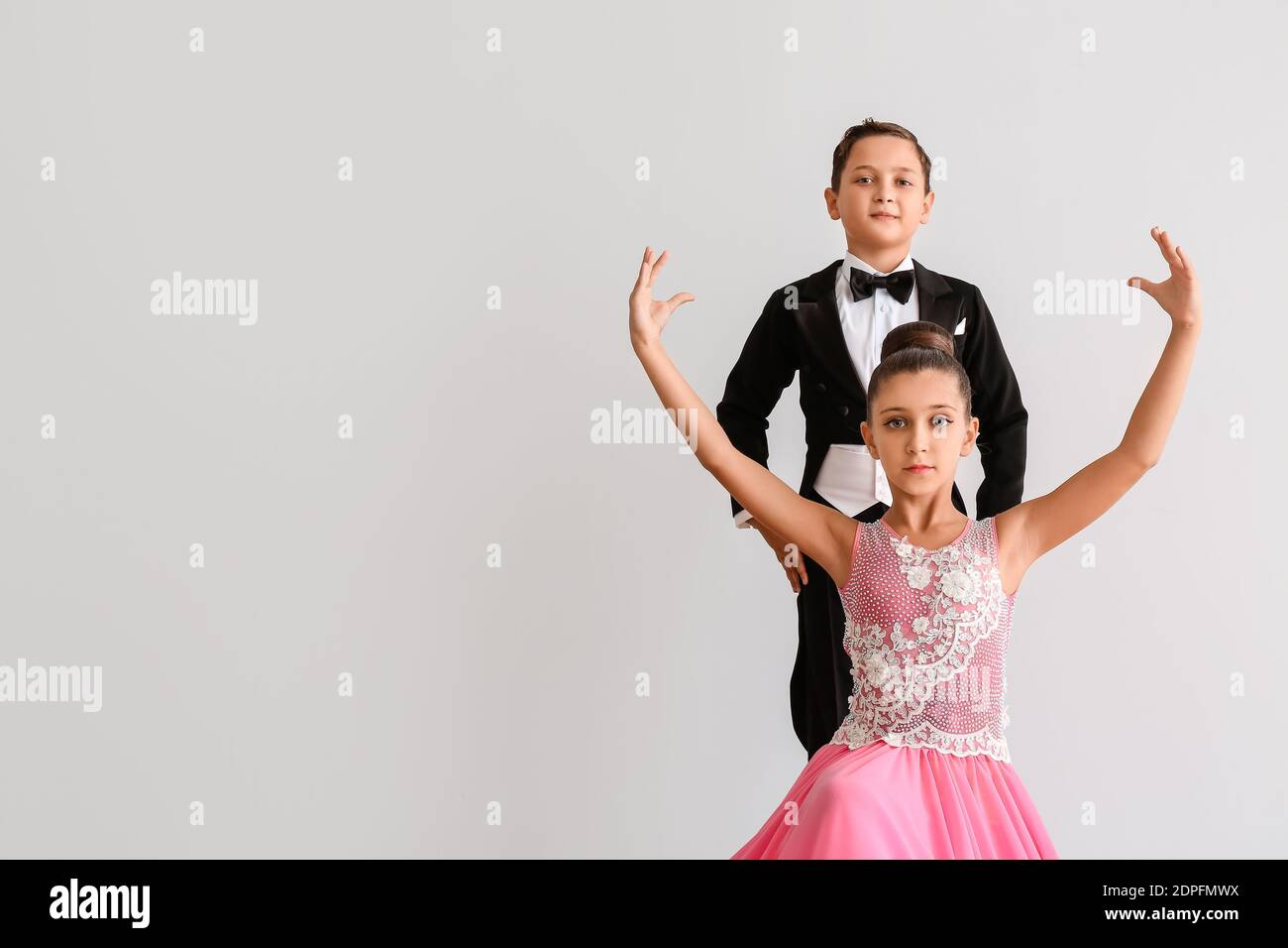 Cute little children dancing against light background Stock Photo - Alamy