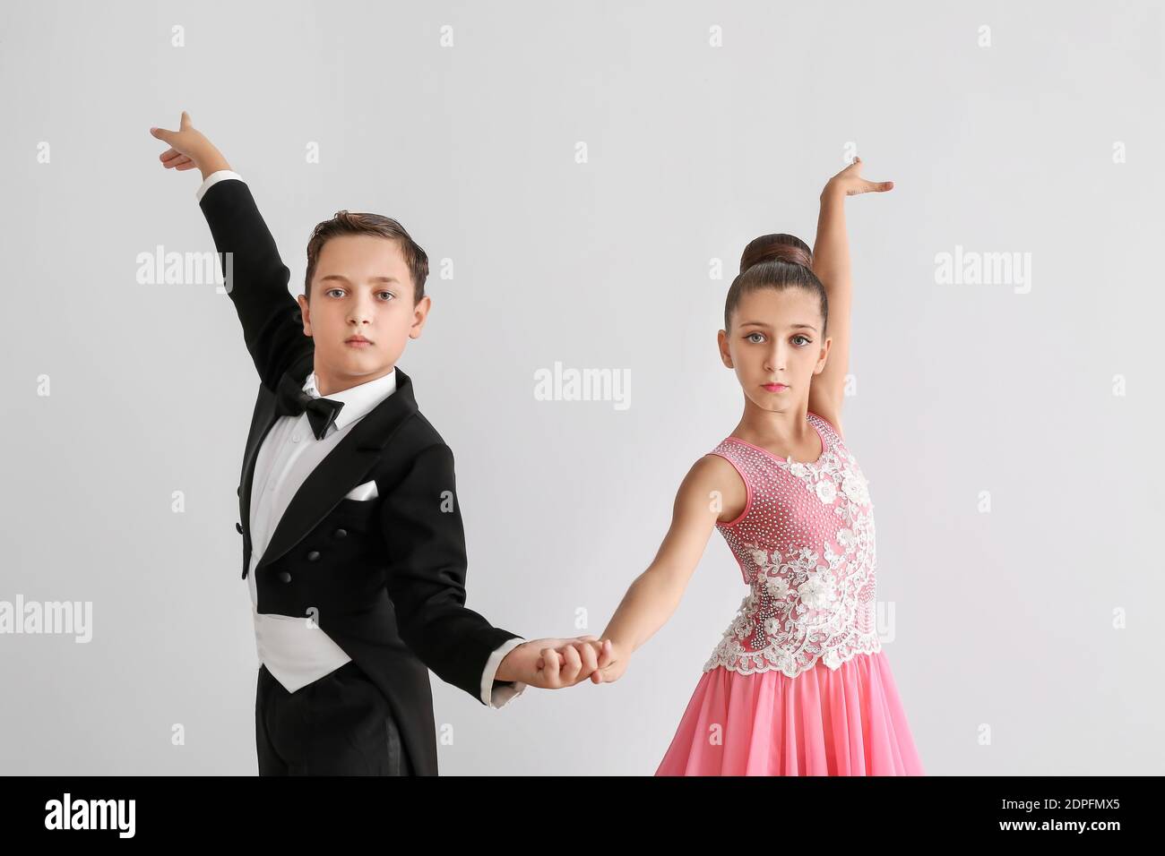 Cute little children dancing against light background Stock Photo - Alamy
