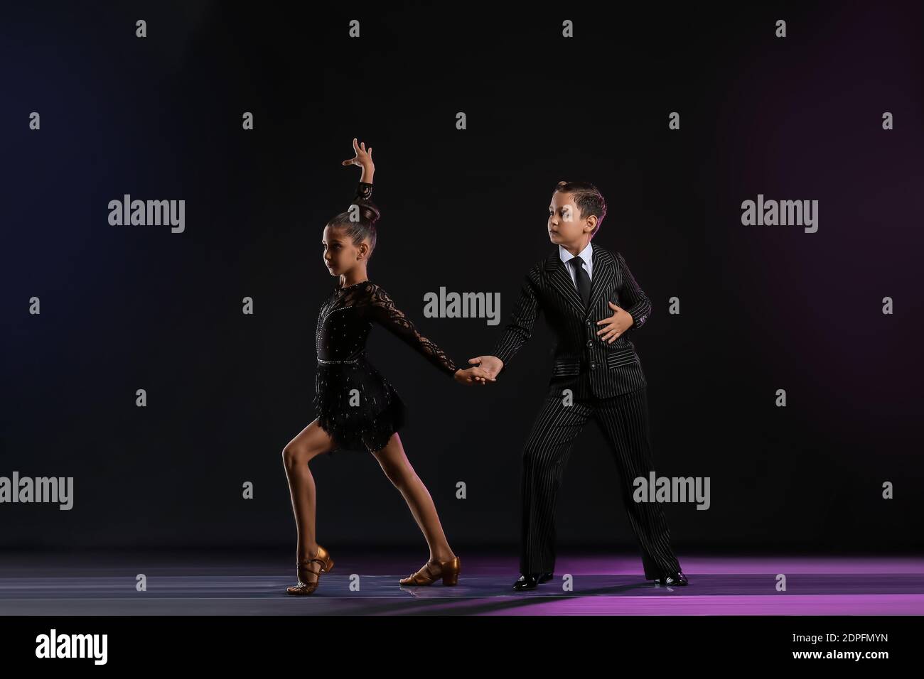 Cute little children dancing against dark background Stock Photo - Alamy