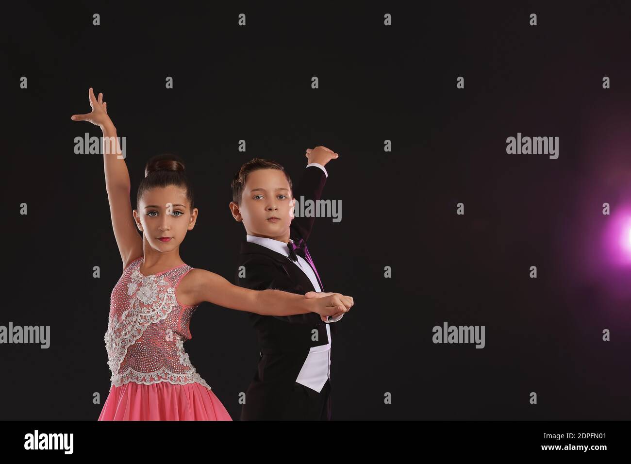 Cute little children dancing against dark background Stock Photo - Alamy