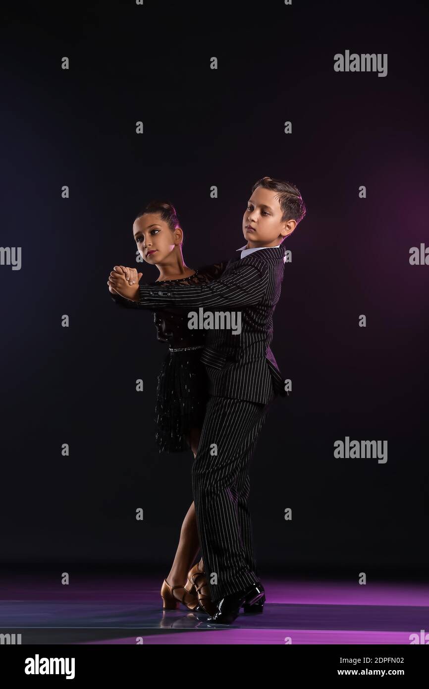 Cute little children dancing against dark background Stock Photo - Alamy