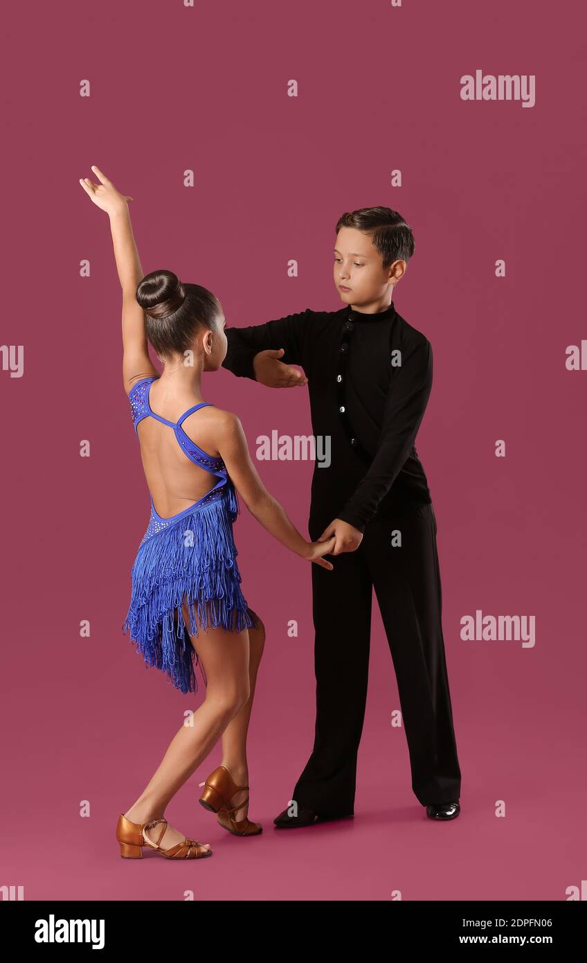 Cute little children dancing against color background Stock Photo - Alamy