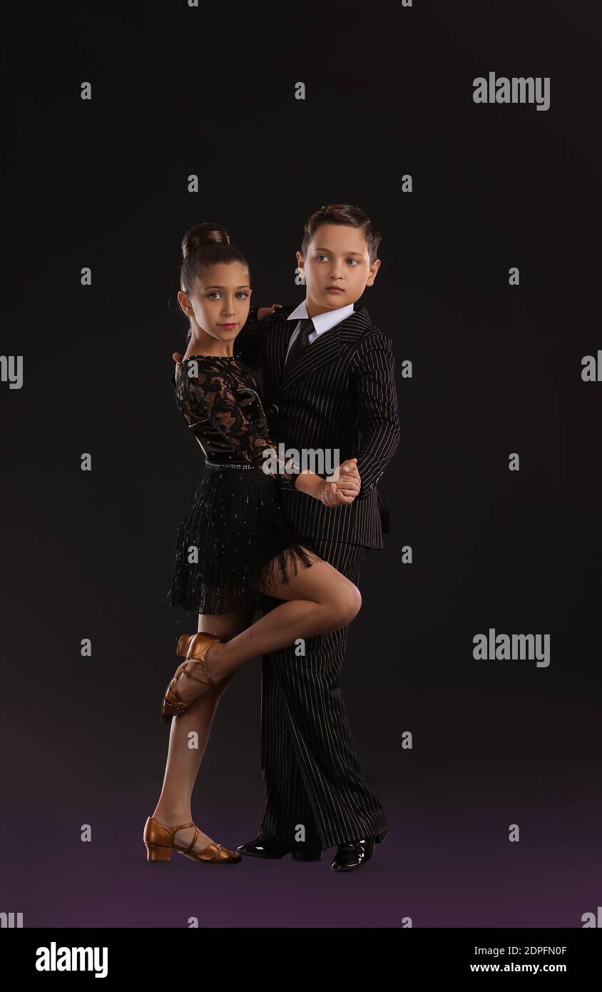 Cute little children dancing against dark background Stock Photo - Alamy