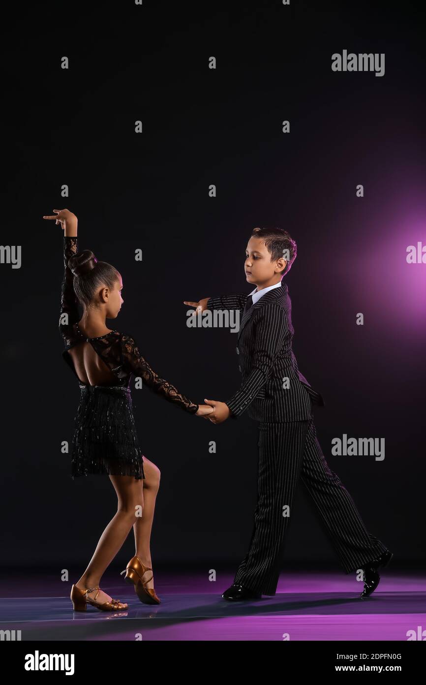 Cute little children dancing against dark background Stock Photo - Alamy