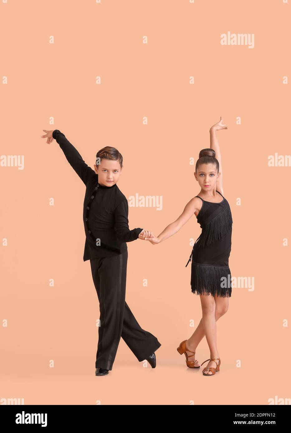 Cute little children dancing against color background Stock Photo - Alamy