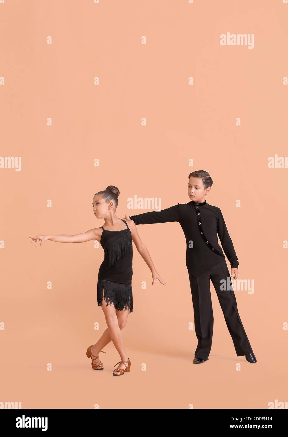Cute little children dancing against color background Stock Photo - Alamy
