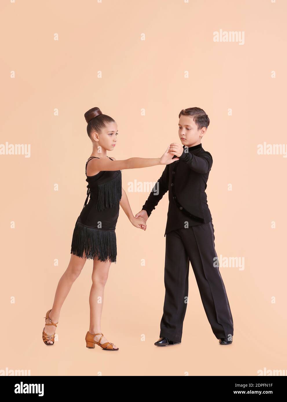 Cute little children dancing against color background Stock Photo - Alamy