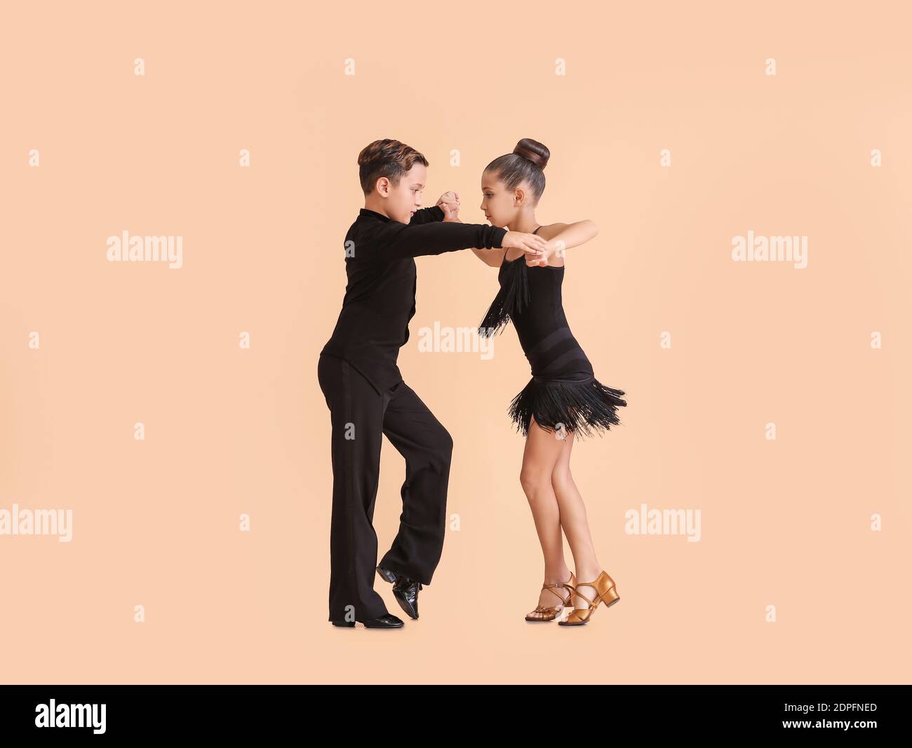 Cute little children dancing against color background Stock Photo - Alamy