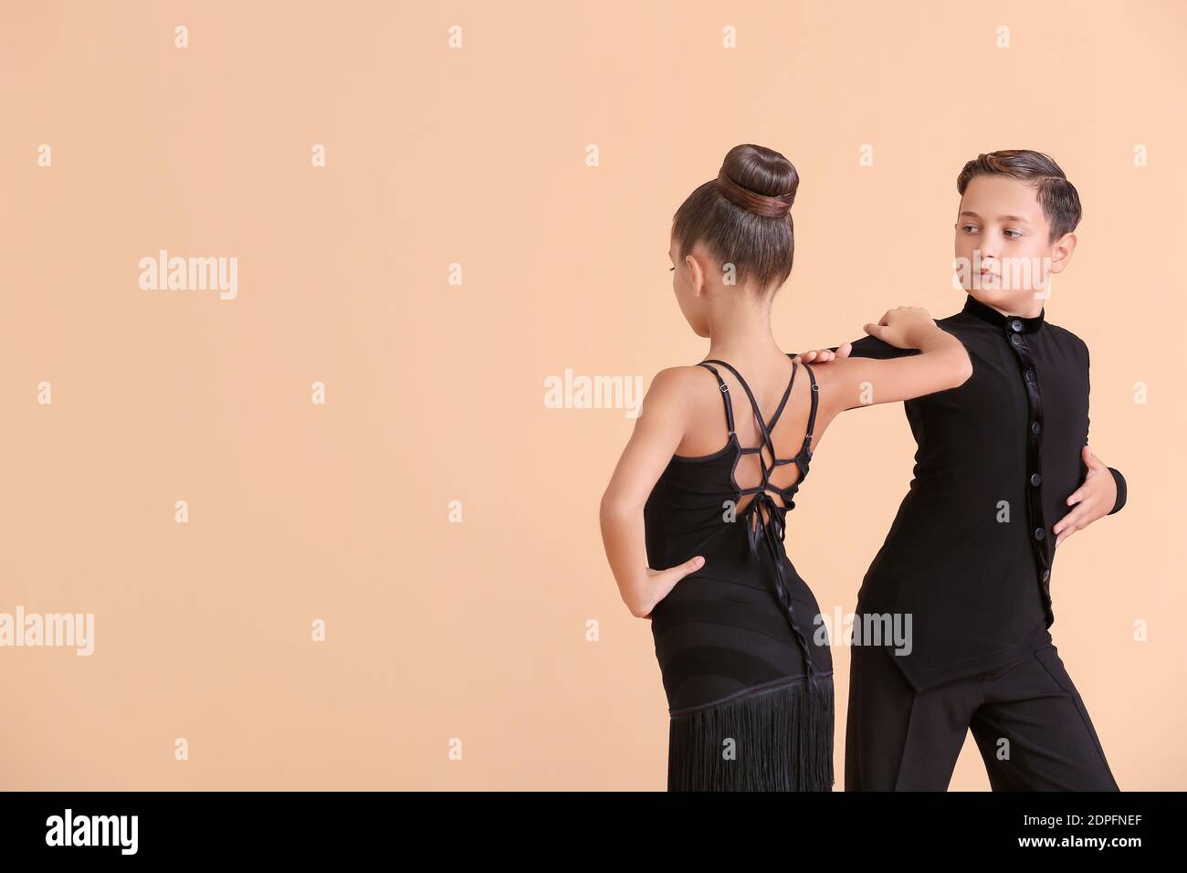 Cute little children dancing against color background Stock Photo - Alamy