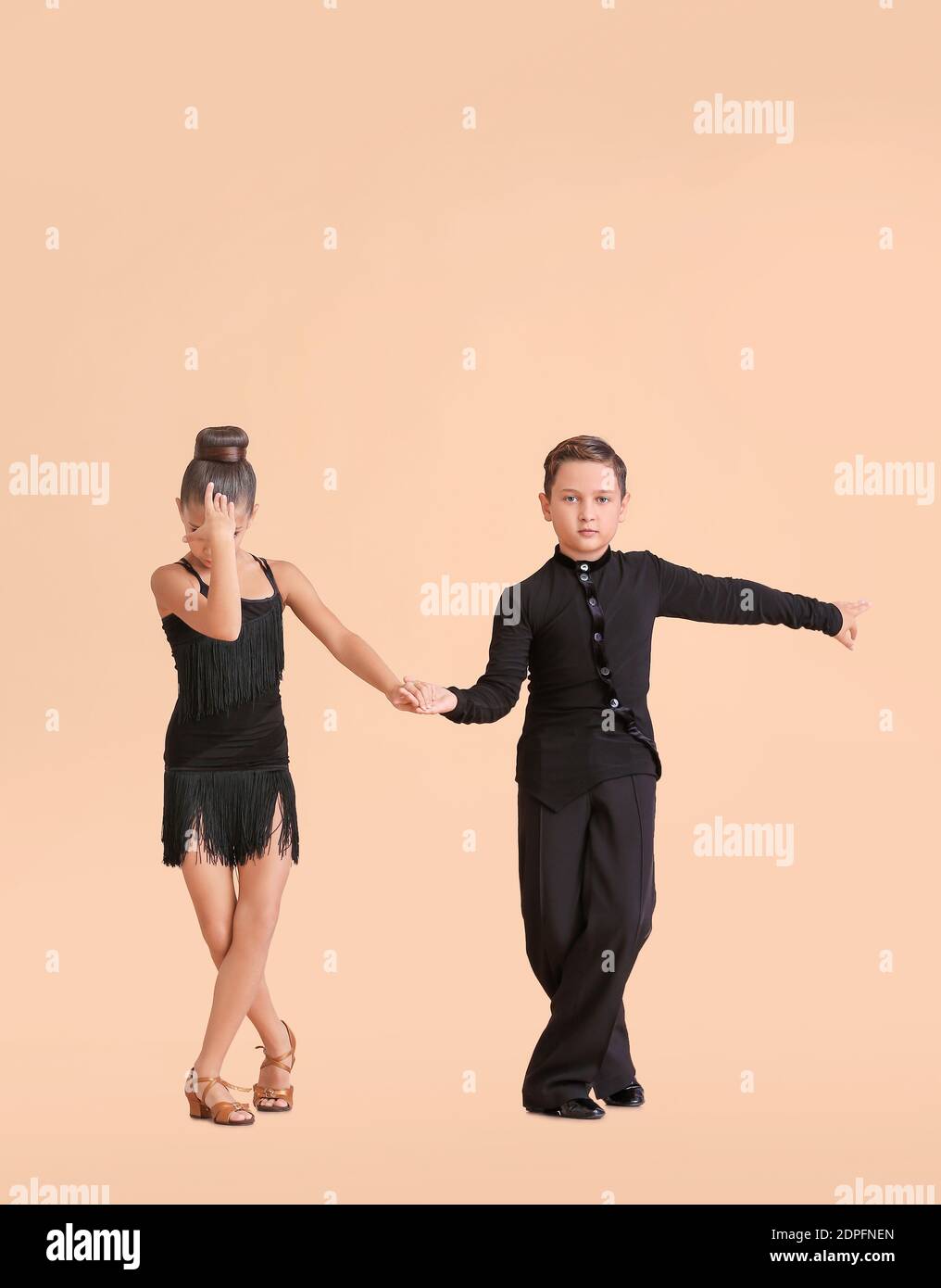Cute little children dancing against color background Stock Photo - Alamy