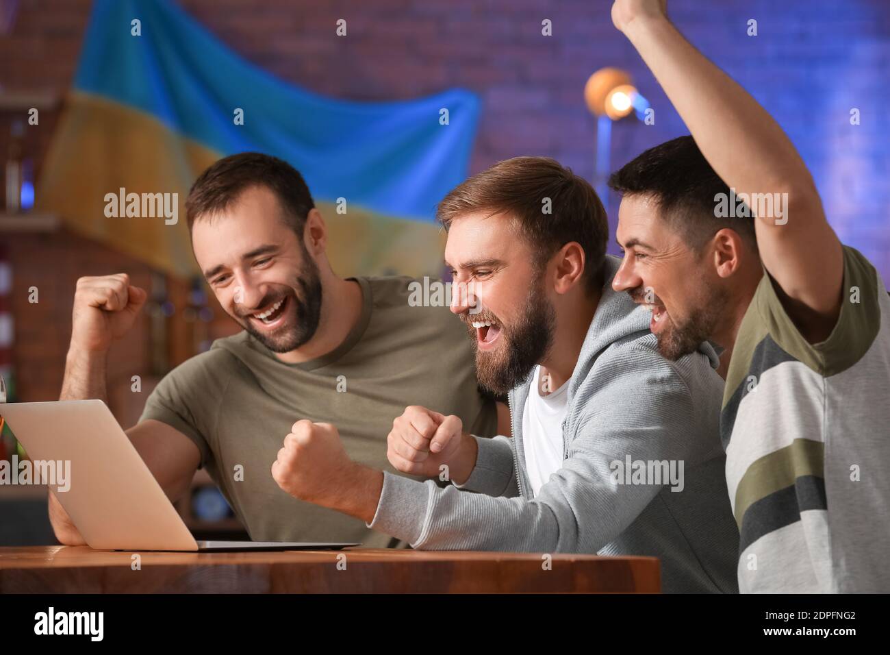 Happy men after winning of their sports bets in pub Stock Photo - Alamy