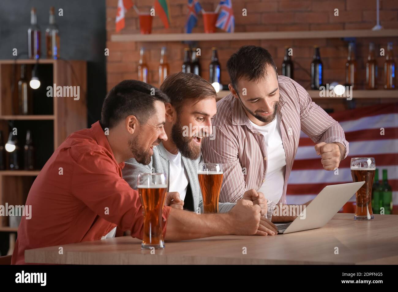 Happy men after winning of their sports bets in pub Stock Photo - Alamy