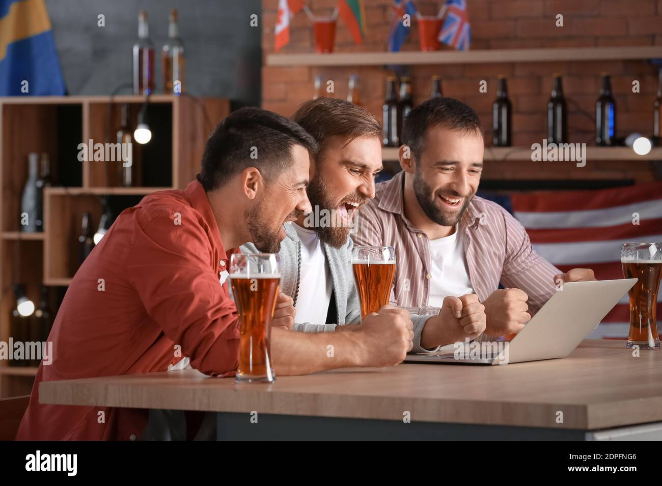 Happy men after winning of their sports bets in pub Stock Photo - Alamy