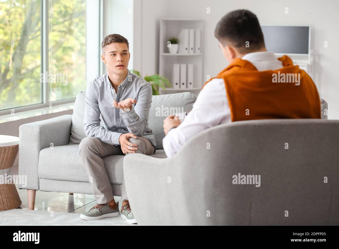 Teenage boy at psychologist's office Stock Photo - Alamy