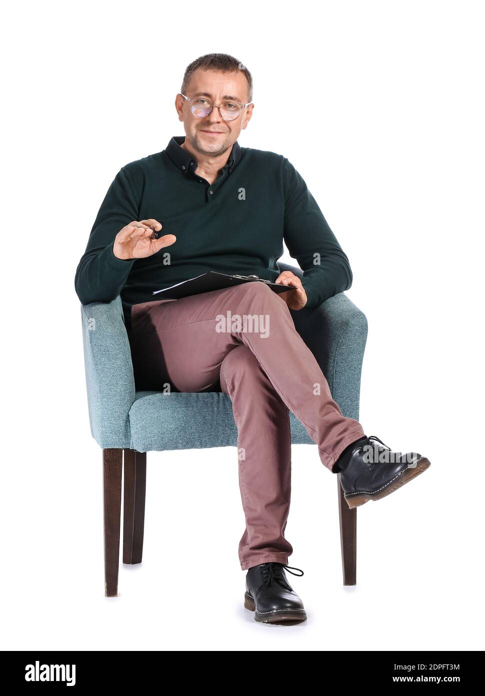Male psychologist sitting in armchair against white background Stock ...