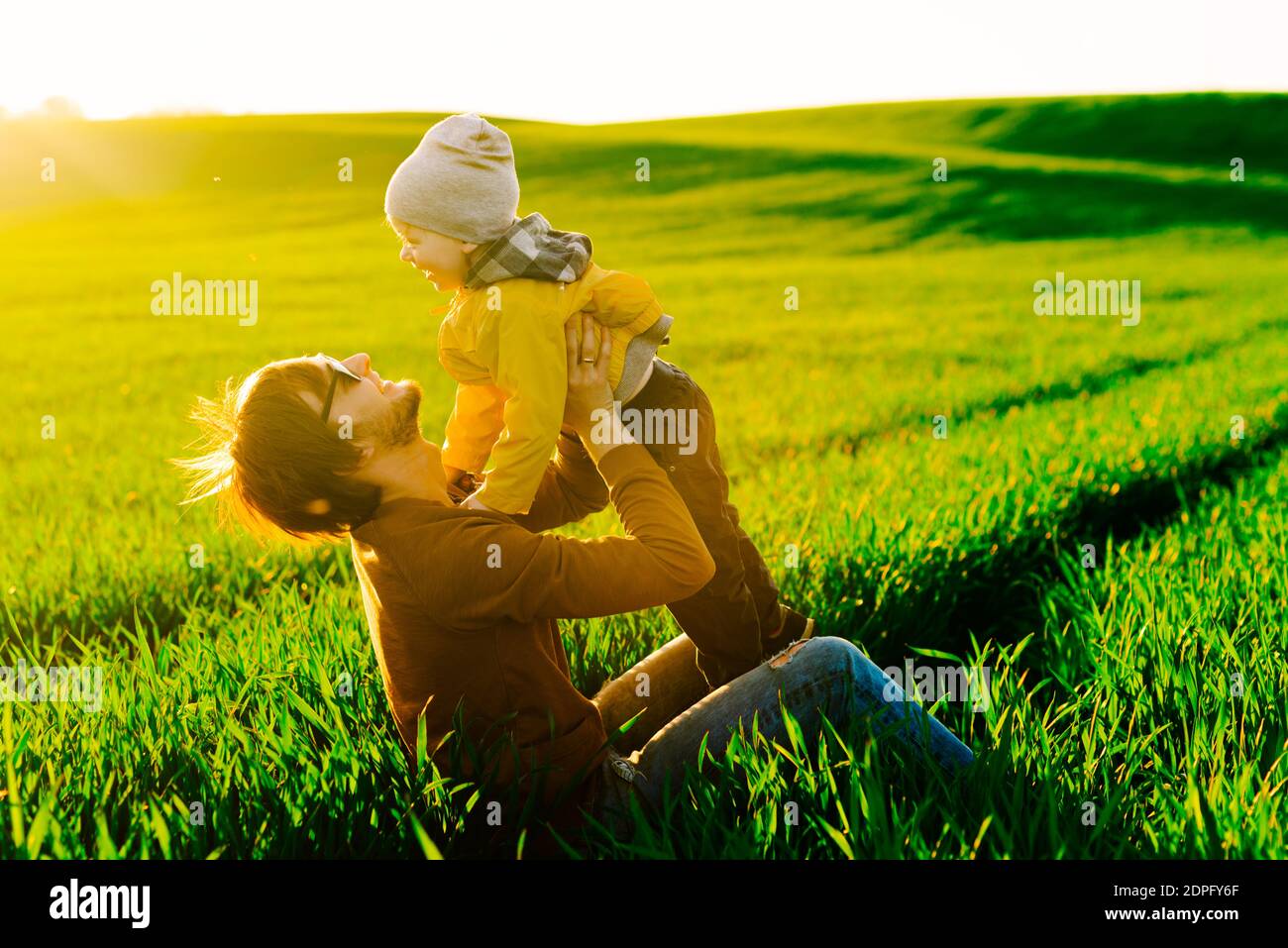 Happy father play with son outdoors. Parent have fun with kid Stock ...