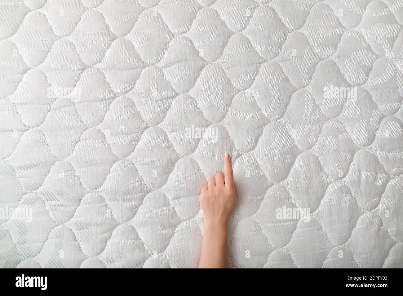 Female hand on soft orthopedic mattress, top view Stock Photo - Alamy