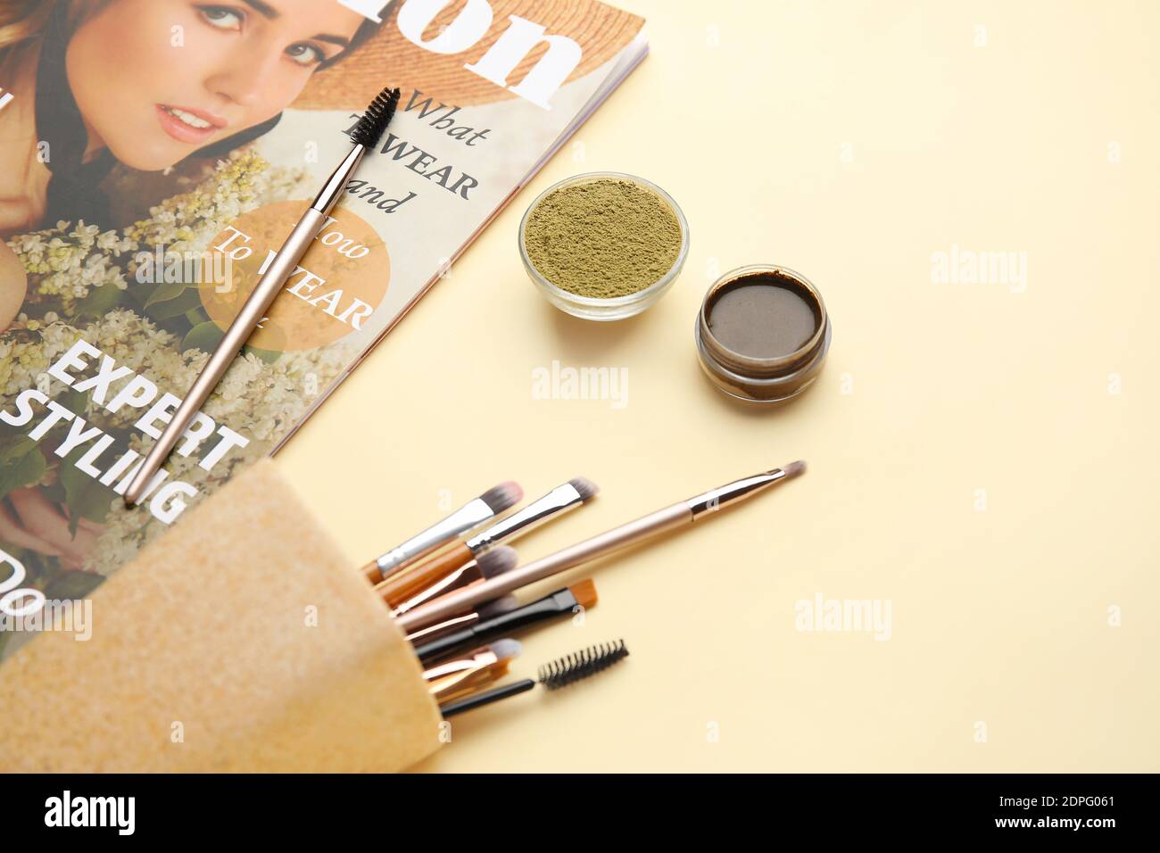 Fashion magazine, henna and brushes on color background Stock Photo - Alamy
